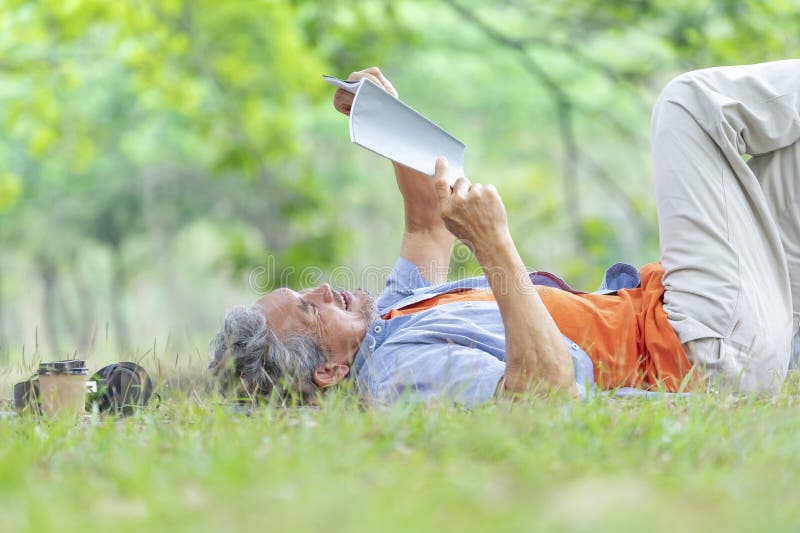 Senior Man Resting Park Lying Grasses Reading Book Stock Photos - Free ...