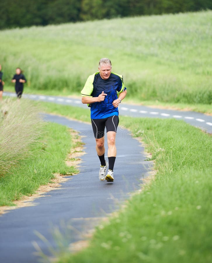 Hes Ahead of the Pack. a Senior Man Running a Long-distance Race. Stock ...