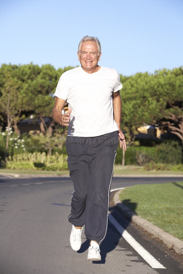 Senior Man Running on Road stock photo. Image of outside - 54939984