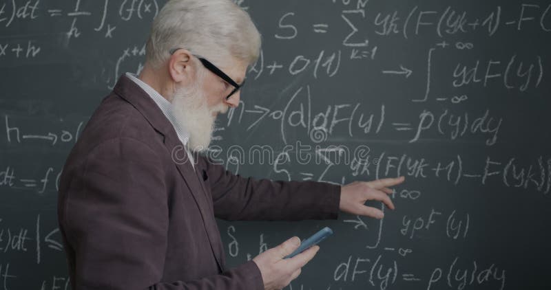 Senior Man Scientist Checking Mathematics Formula on Chalkboard and ...