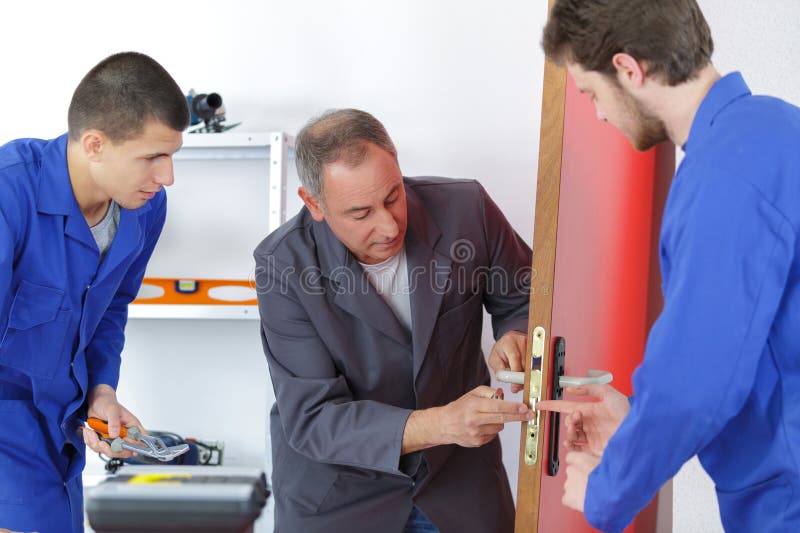 Senior Man Showing Students How To Fix Door with Screwdriver Stock ...