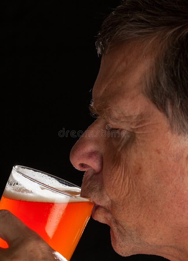 Senior Man Sipping from Pint Glass Beer Stock Image - Image of backlit ...