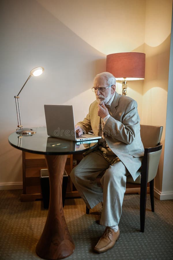 Senior Man Sitting at the Laptop and Looking Busy Stock Photo - Image ...
