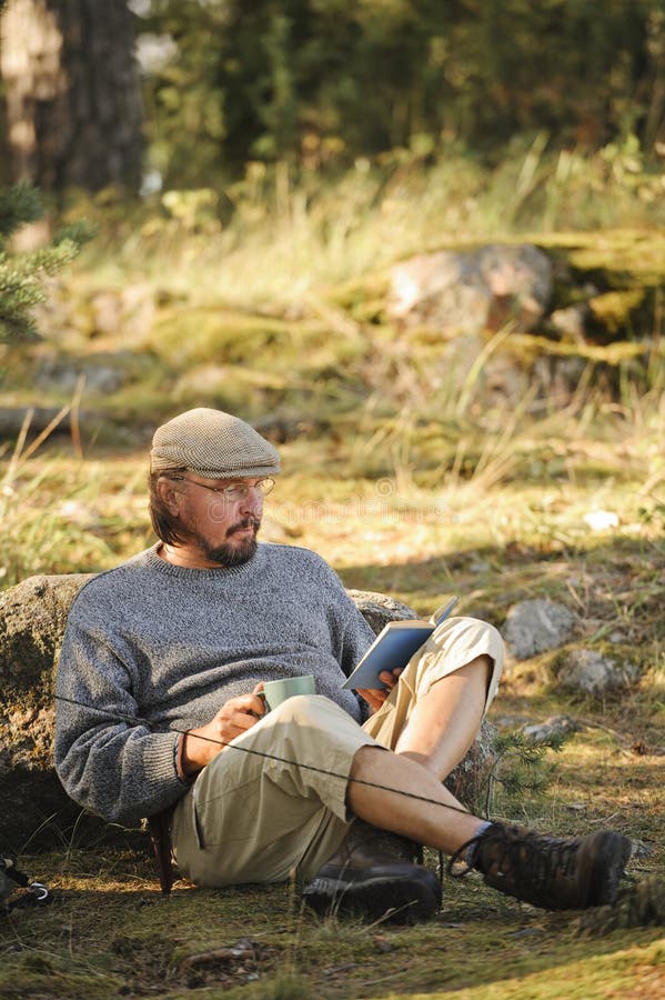 Senior Man Sitting Outside Reading a Book Stock Photo - Image of light ...