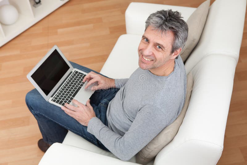 Senior Man Sitting in Sofa and Using Laptop Stock Image - Image of ...