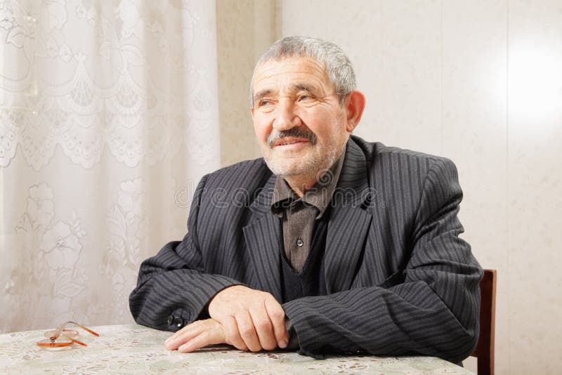 Senior Man Sitting at Table Stock Photo - Image of senior, pensive ...
