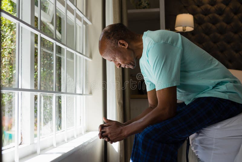 Senior Man Sitting by Window in Bedroom at Home Stock Photo - Image of ...