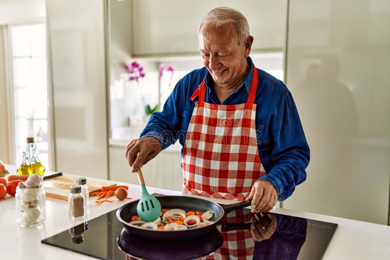 Senior Man Smiling Confident Cooking at Kitchen Stock Photo - Image of ...