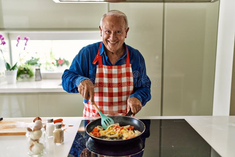 Senior Man Smiling Confident Cooking at Kitchen Stock Image - Image of ...