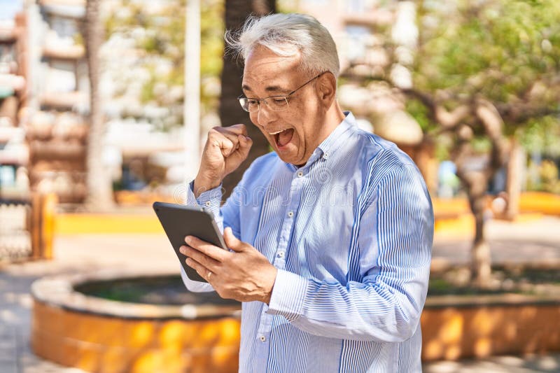 Senior Man Smiling Confident Using Touchpad at Park Stock Image - Image ...