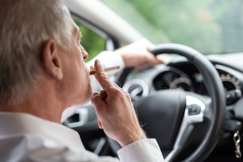 Man Smoking a Cigarette while Driving Stock Photo - Image of danger ...