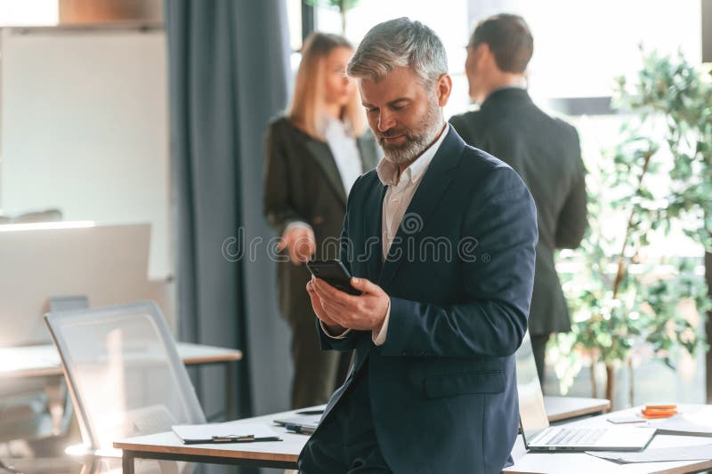 Senior Man is Standing in Front of Colleagues. Group of Business People ...