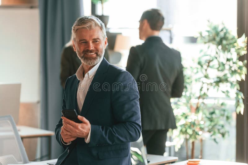 Senior Man is Standing in Front of Colleagues. Group of Business People ...