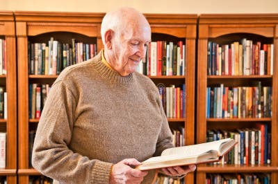 Senior Man Standing and Reading Book in Library Stock Photo - Image of ...
