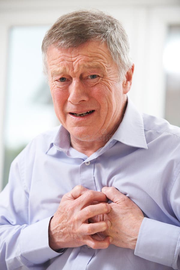 Senior Man Suffering Heart Attack at Home Stock Image - Image of people ...