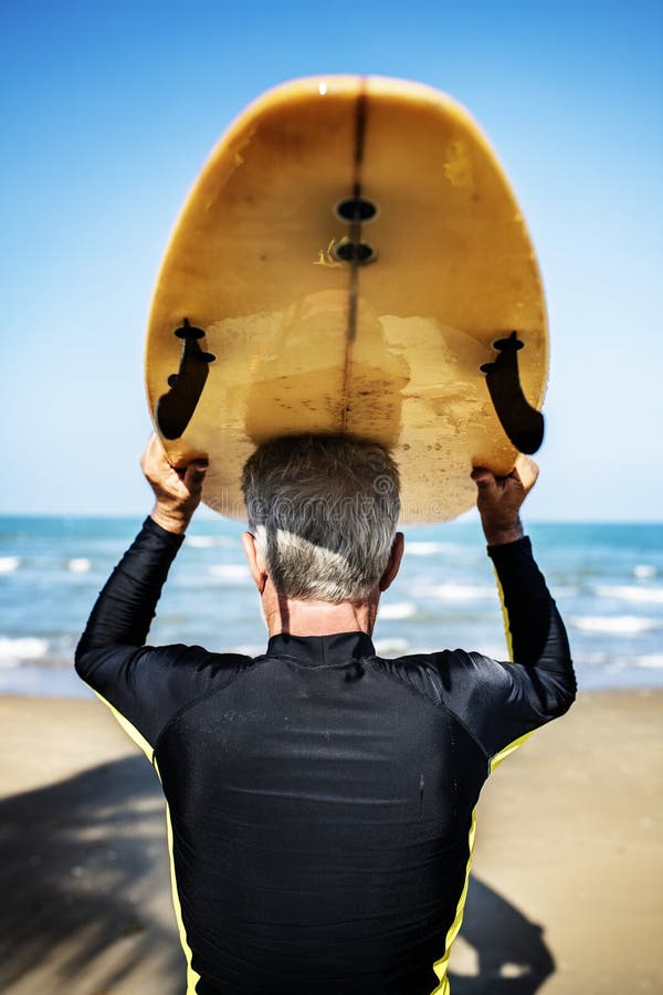 A Senior Man with a Surfboard Stock Photo - Image of ocean, sports ...