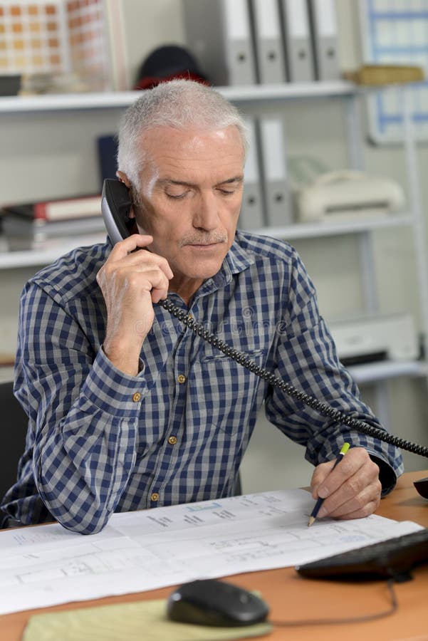 Senior Man Taking Call at Desk Stock Photo - Image of groomed ...