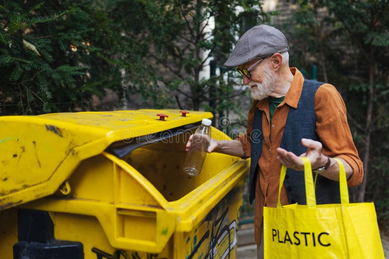 Senior Man Throwing Plastic Waste, Bottles into Recycling Container in ...