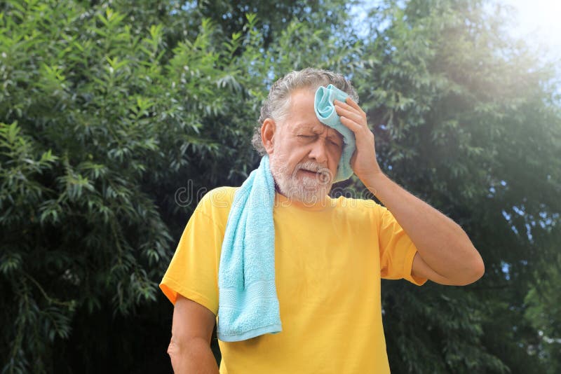 Senior Man with Towel Suffering from Heat Stroke Stock Photo - Image of ...