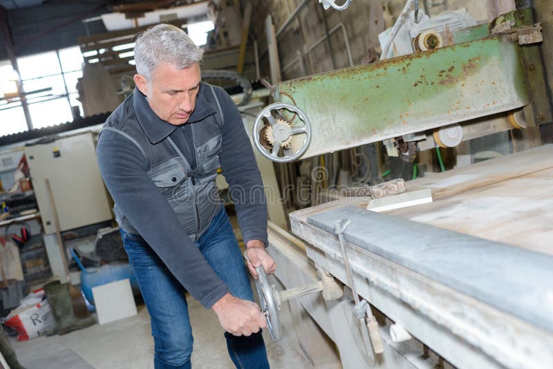 Senior Man Turning Wheel on Work Bench Stock Photo - Image of turning ...