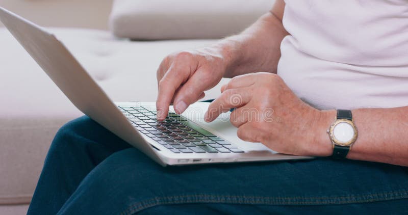 A Senior Man Types on the Keyboard of His Laptop Stock Video - Video of ...
