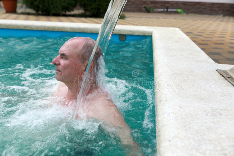 Senior Man Under Stream of Water in Pool Stock Image - Image of healthy ...