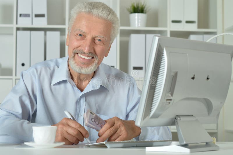 Senior man using computer stock photo. Image of personal - 82977632