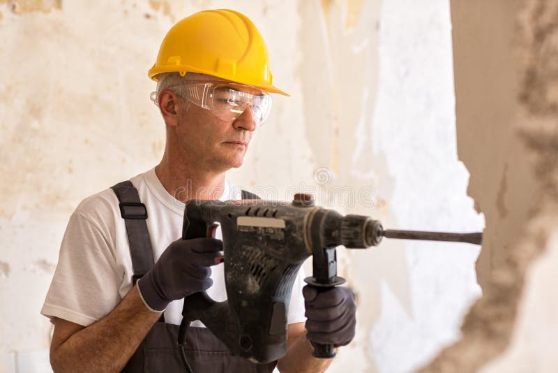 Senior Man Using Drill in the Reconstruction of the Building Stock ...