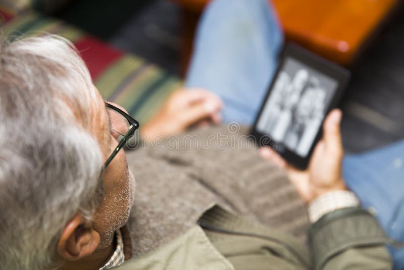 Senior Man Using an Ebook Reader Stock Image - Image of home, hold ...