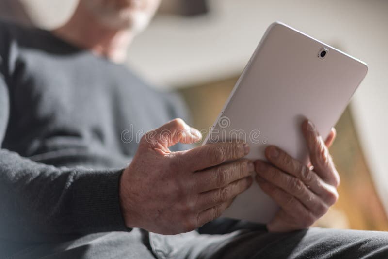 Senior Man Using His Tablet, Hard Light Effect Stock Image - Image of ...