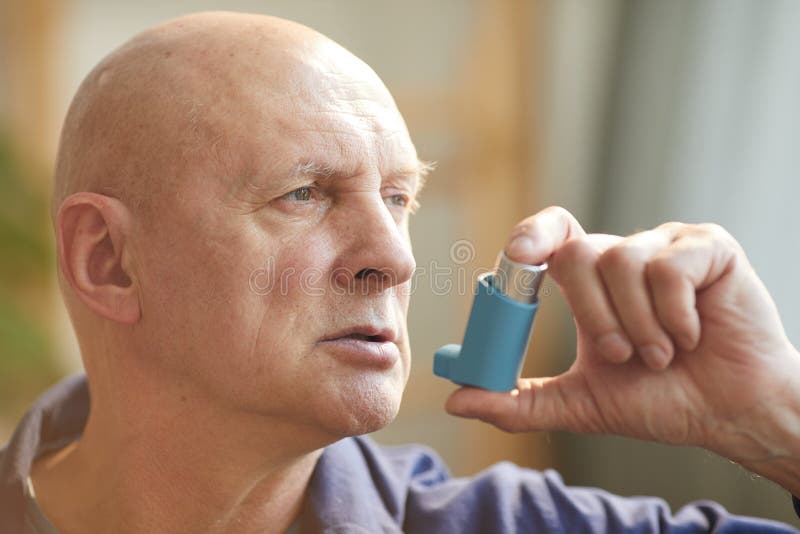 Senior Man Using Inhaler stock image. Image of medical - 194385571