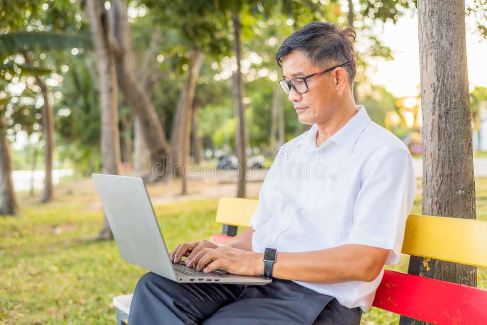 Senior Man Using Laptop Computer at the Park Stock Photo - Image of ...
