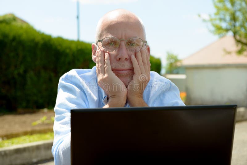 Senior Man Using a Laptop Outside Stock Photo - Image of glasses ...