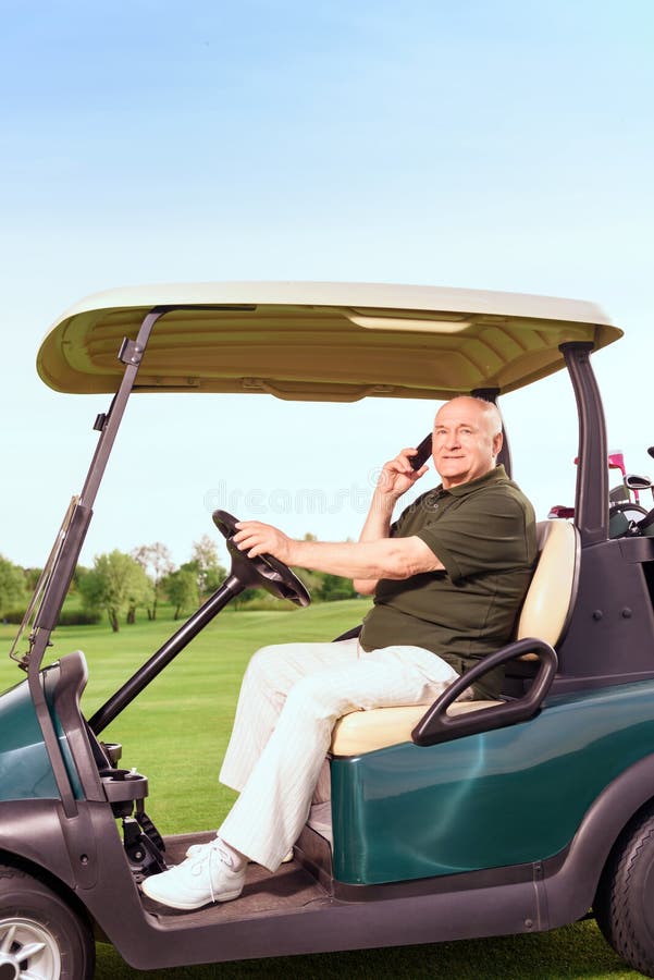 Senior Man Using Mobile Phone and Driving Cart Stock Photo - Image of ...