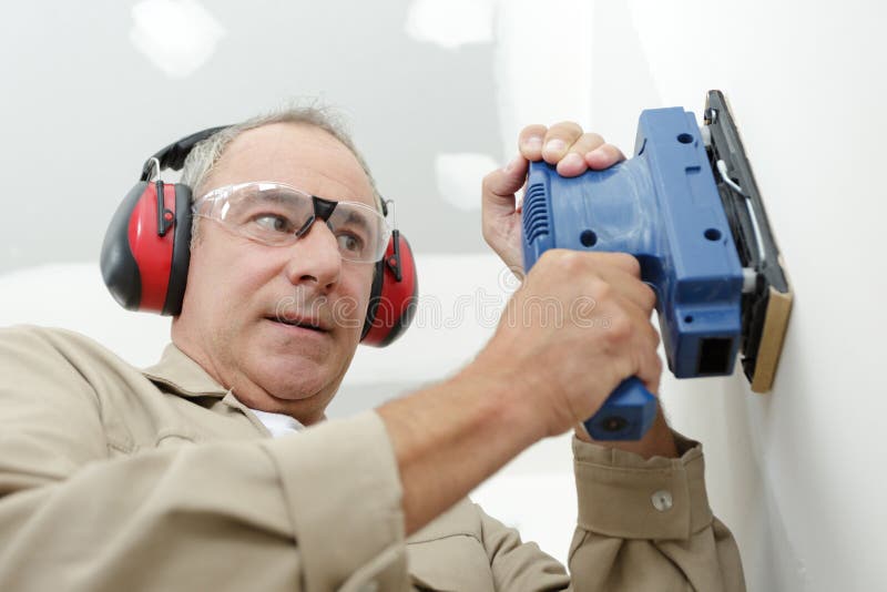 Senior Man Using Sander on Plasterboard Wall Stock Image - Image of ...