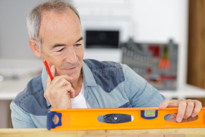 Senior Man Using Spirit Level Stock Image - Image of person ...