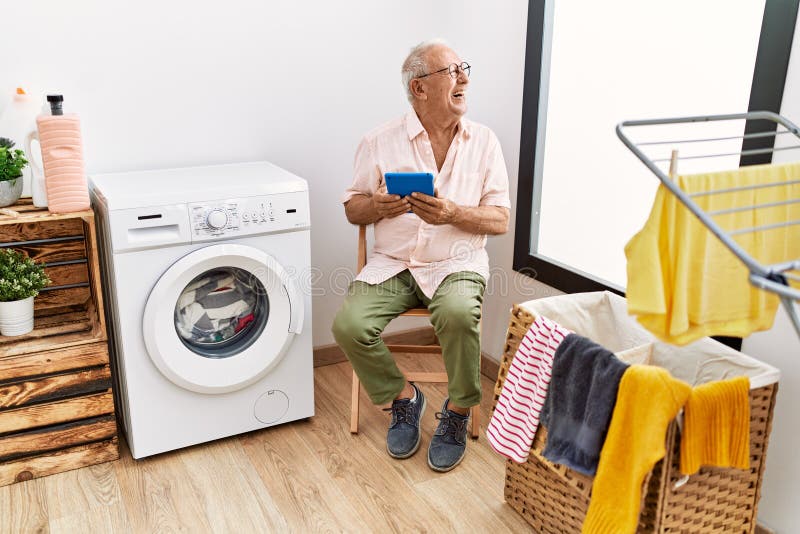 Senior Man Using Touchpad Waiting for Washing Machine at Laundry Room ...