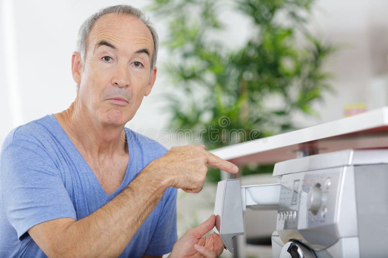 Senior Man Using Washing Machine Stock Photo - Image of person, laundry ...