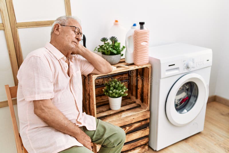 Senior Man Waiting for Washing Machine Sleeping on Chair at Laundry ...
