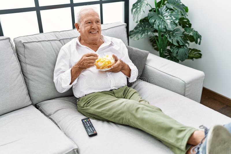 Senior Man Watching Movie Sitting on Sofa at Home Stock Image - Image ...