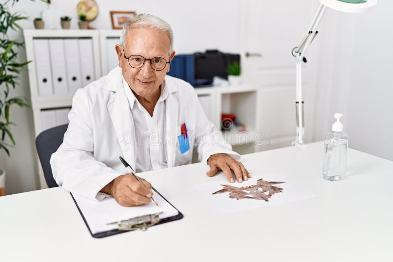 Senior Man Wearing Doctor Uniform Doing Rorscharch Test at Clinic Stock ...
