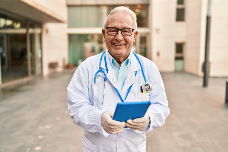 Senior Man Wearing Doctor Uniform Using Touchpad at Street Stock Photo ...