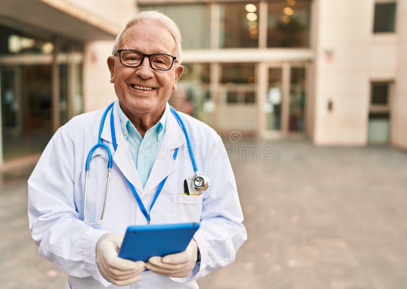 Senior Man Wearing Doctor Uniform Using Touchpad at Street Stock Photo ...