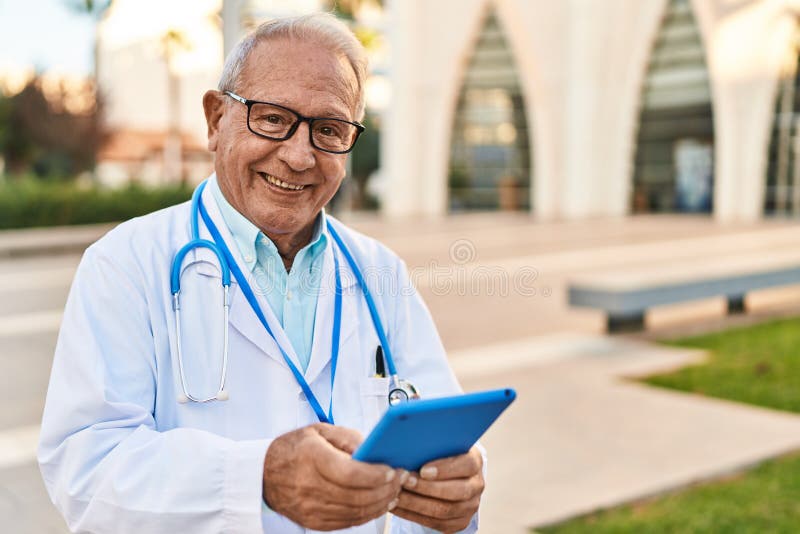 Senior Man Wearing Doctor Uniform Using Touchpad at Street Stock Photo ...