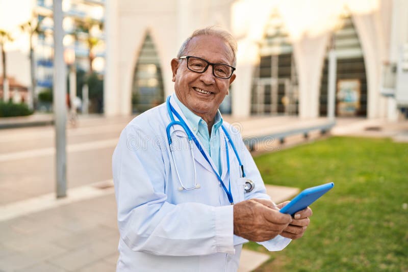 Senior Man Wearing Doctor Uniform Using Touchpad at Street Stock Photo ...