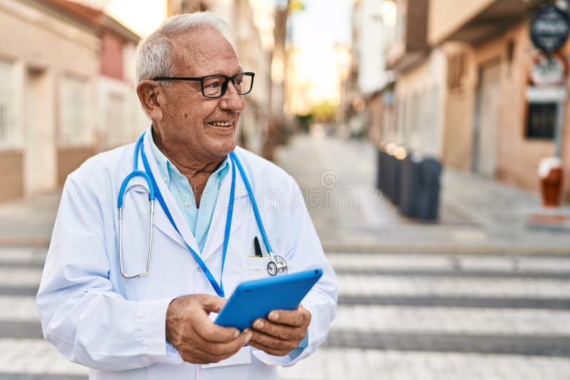 Senior Man Wearing Doctor Uniform Using Touchpad at Street Stock Image ...