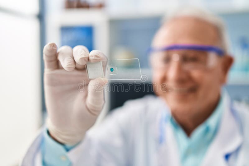 Senior Man Wearing Scientist Uniform Holding Sample at Laboratory Stock ...