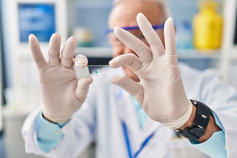 Senior Man Wearing Scientist Uniform Holding Sample at Laboratory Stock ...