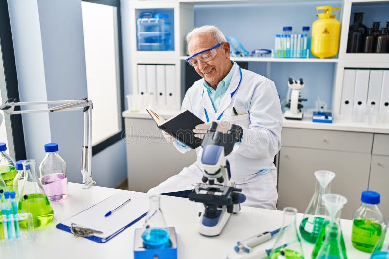 Senior Man Wearing Scientist Uniform Reading Book at Laboratory Stock ...