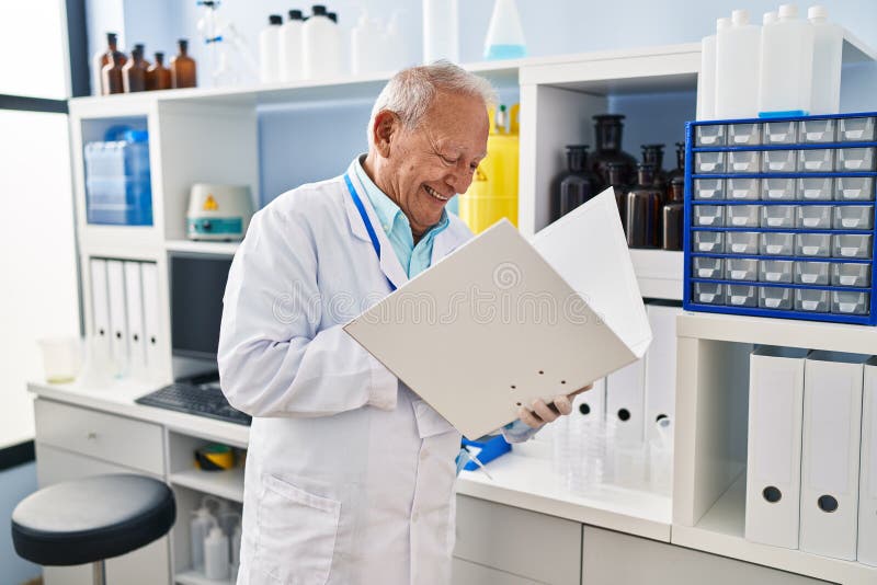 Senior Man Wearing Scientist Uniform Reading Document at Laboratory ...